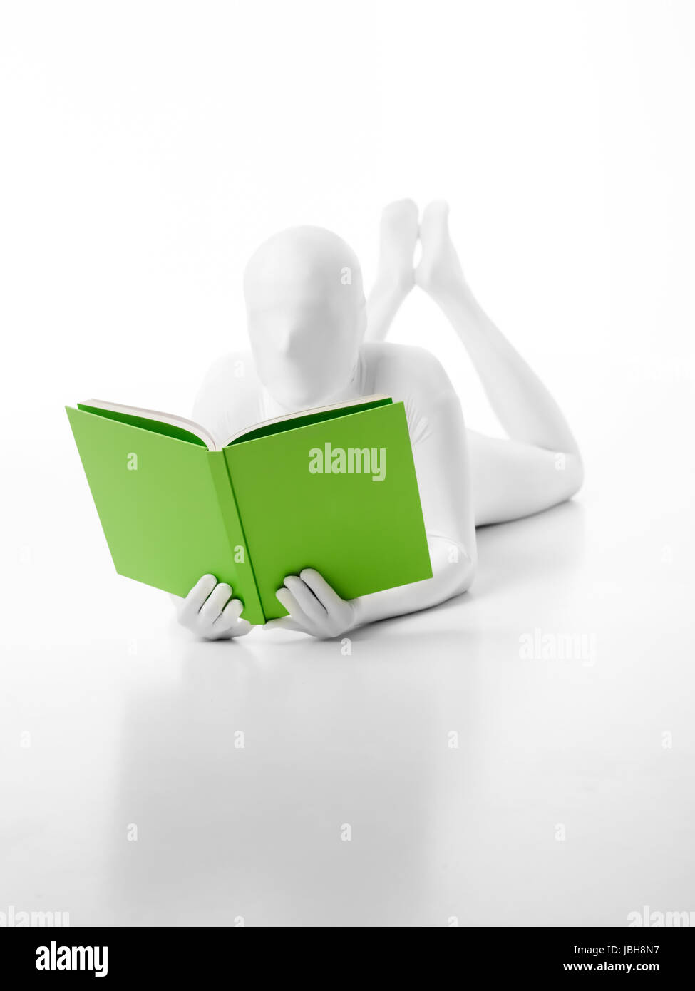 faceless man dressed white with a book in hand sitting on the floor ...