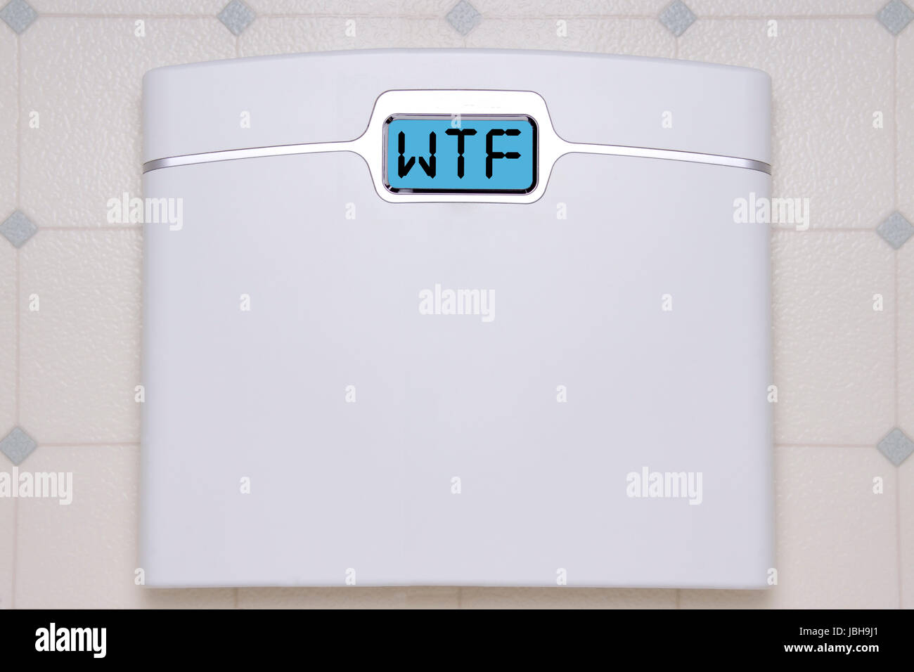 A white digital bathroom scale displaying the text message WTF Stock ...
