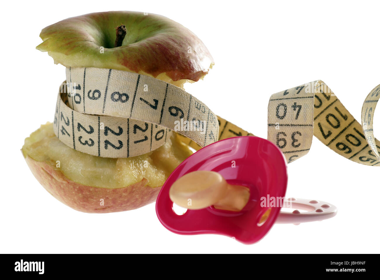 apple with measure tape and pacifier over a white background Stock ...