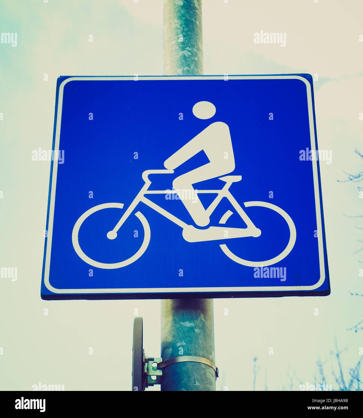 Vintage retro looking Bike lane traffic sign over blue sky Stock Photo ...
