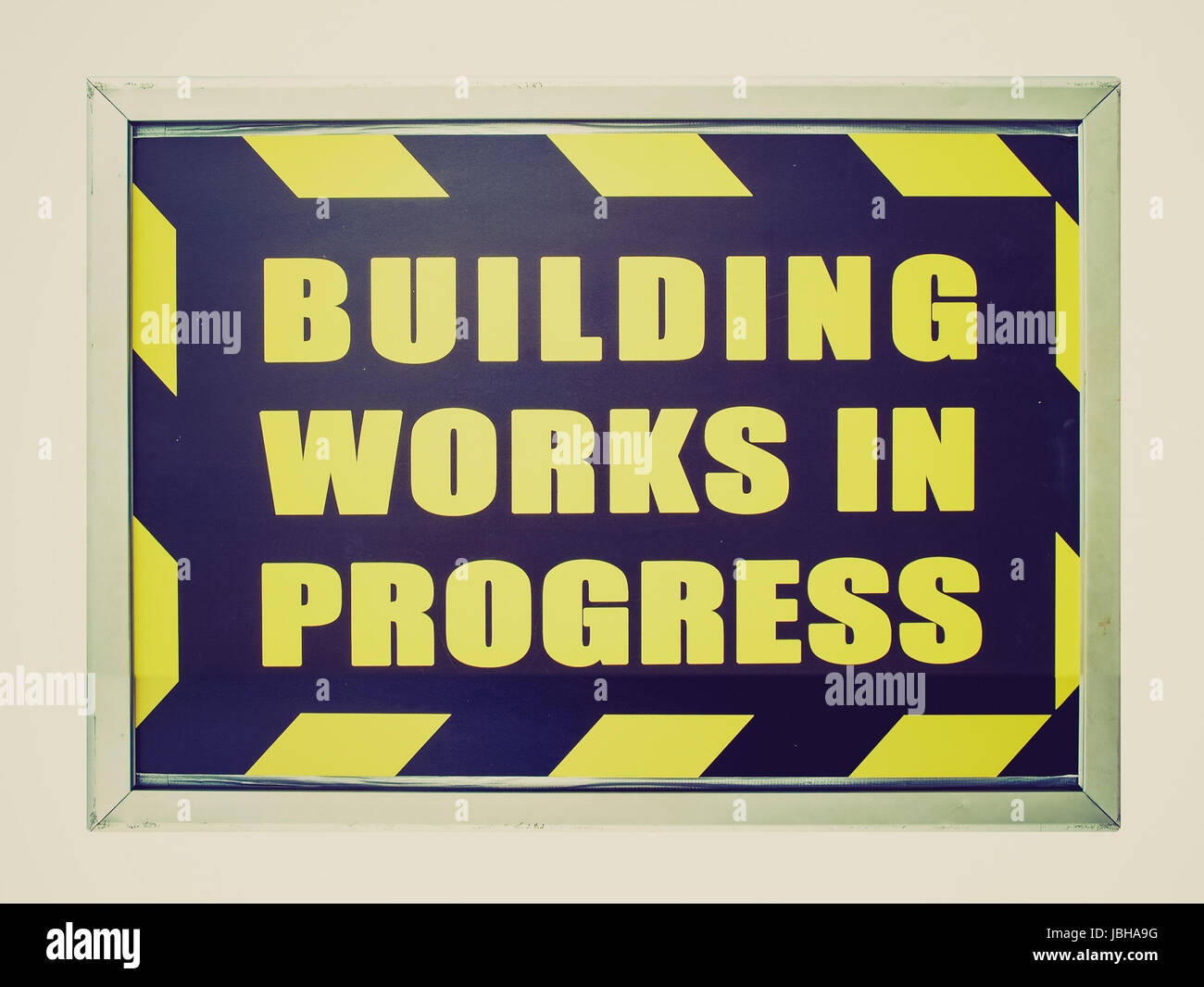 Vintage retro looking Building works in progress sign isolated over ...