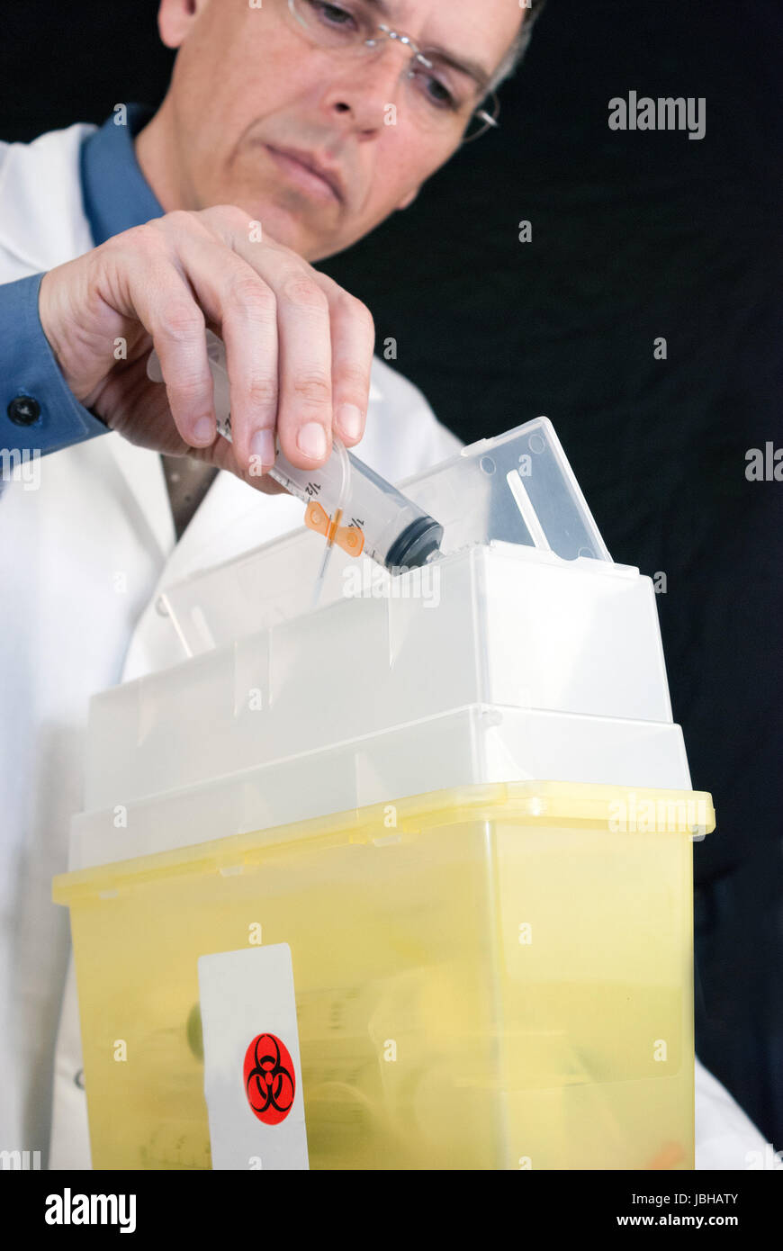 Close-up of a Doctor dropping a syringe with butterfly needle attached ...