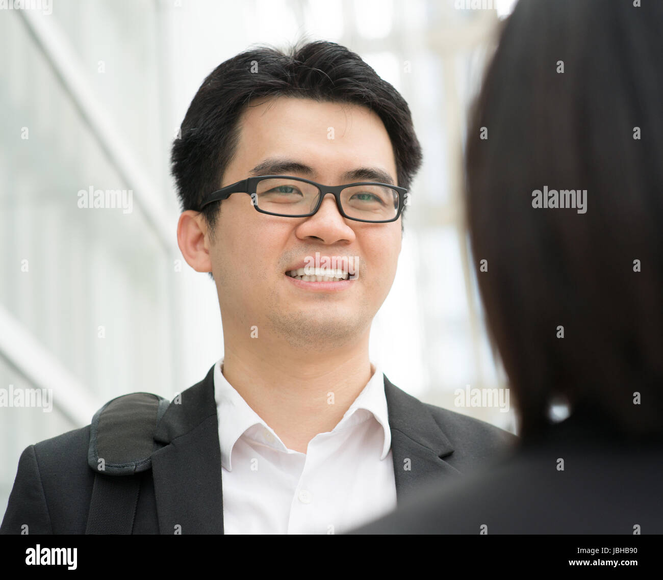 Young Asian business team having discussion over office Stock Photo - Alamy