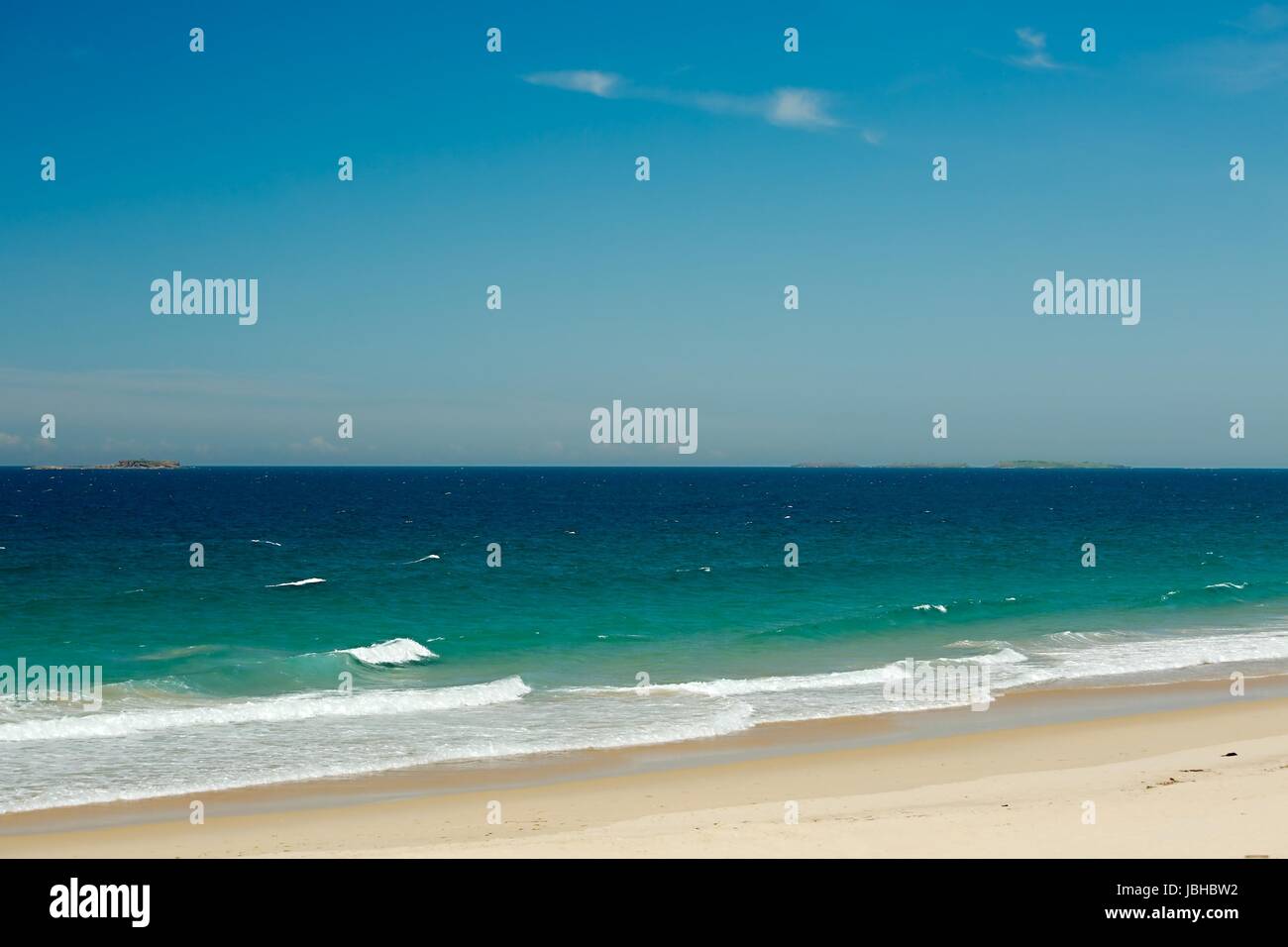 Sandy beach with waves of the see Stock Photo - Alamy