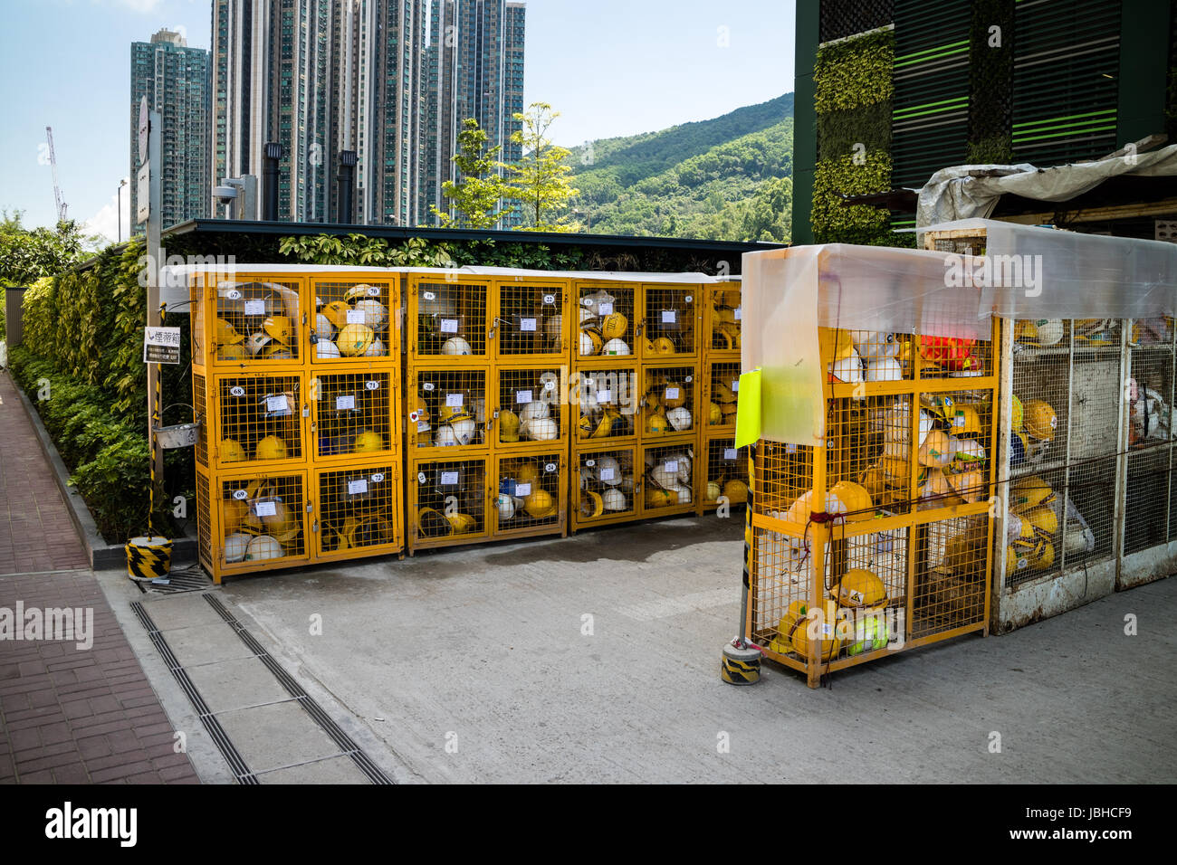 Construction safety helmets stored in cage lockers at construction site ...