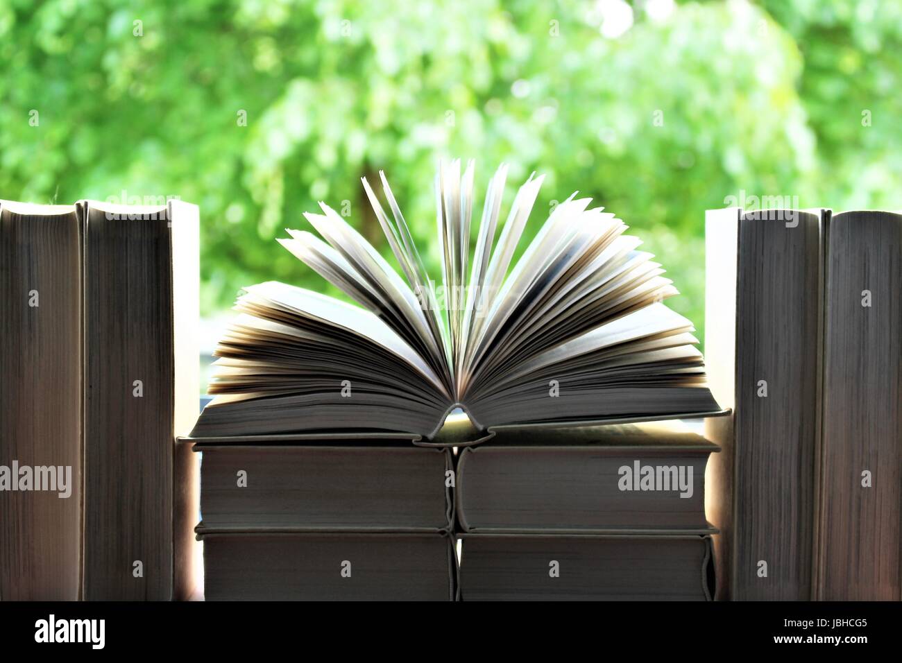 An image of book in front of a open window Stock Photo - Alamy