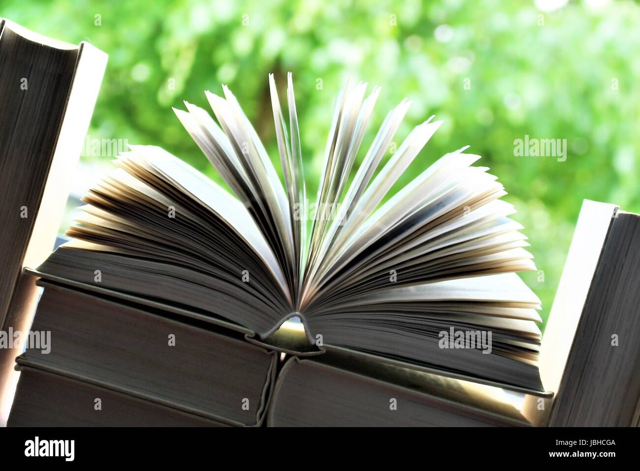An image of book in front of a open window Stock Photo - Alamy