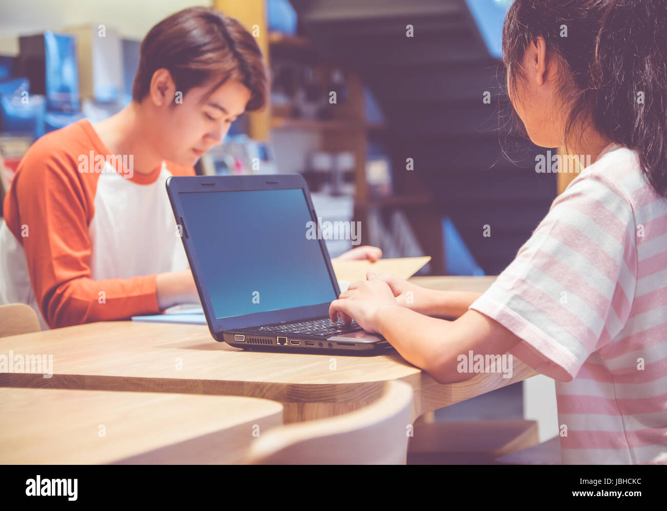 Teenage students studying together use laptop computer for e-learning ...