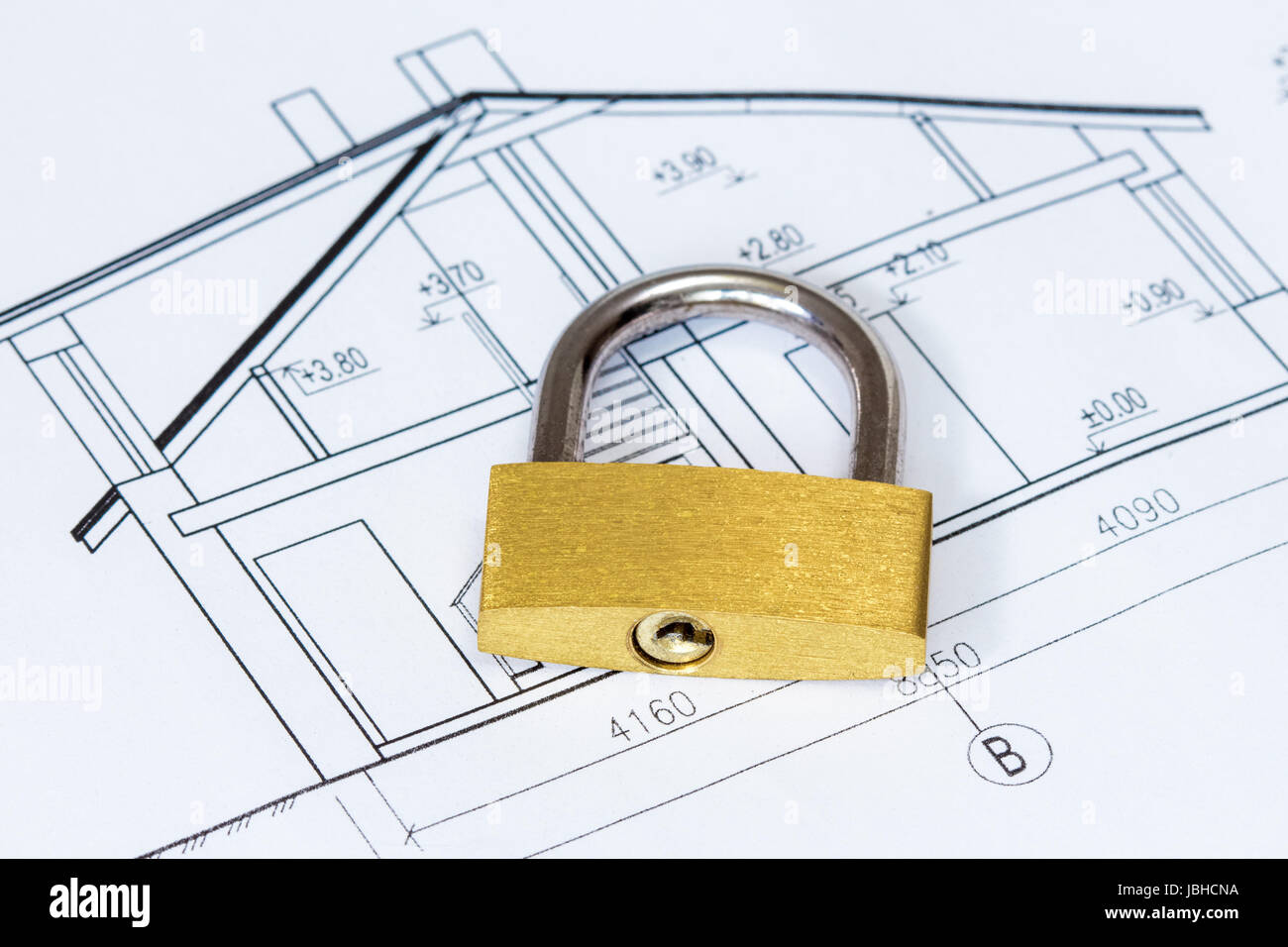 Concept of housing. Architectural house drawings with yellow padlock ...