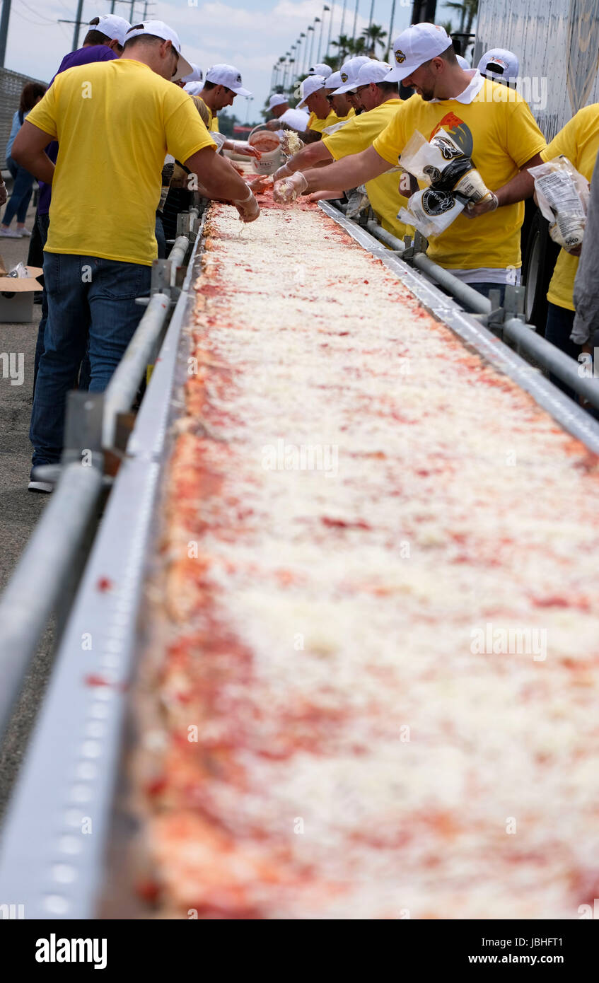 Los Angeles, Italy. 18th May, 2016. Volunteers work on a pizza as they ...