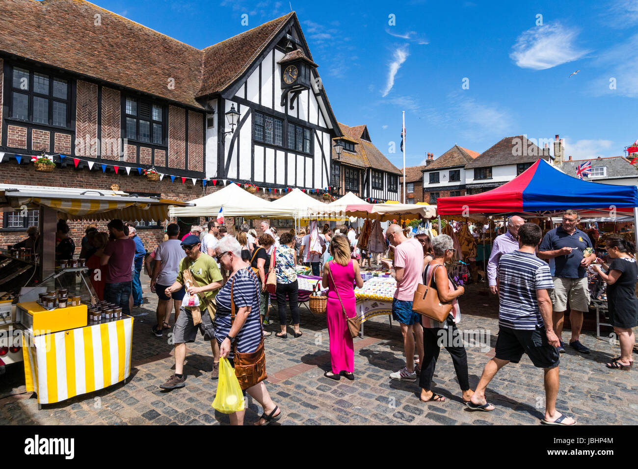People wandering around busy French market set up at Sandwich town ...