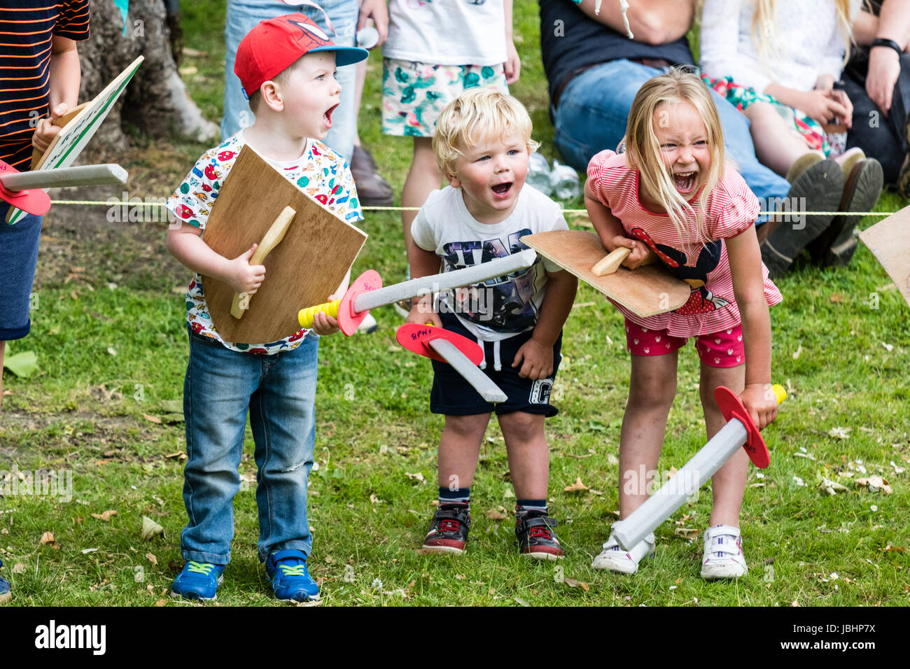 Medieval re-enactment event, row of three children, two boys and one ...