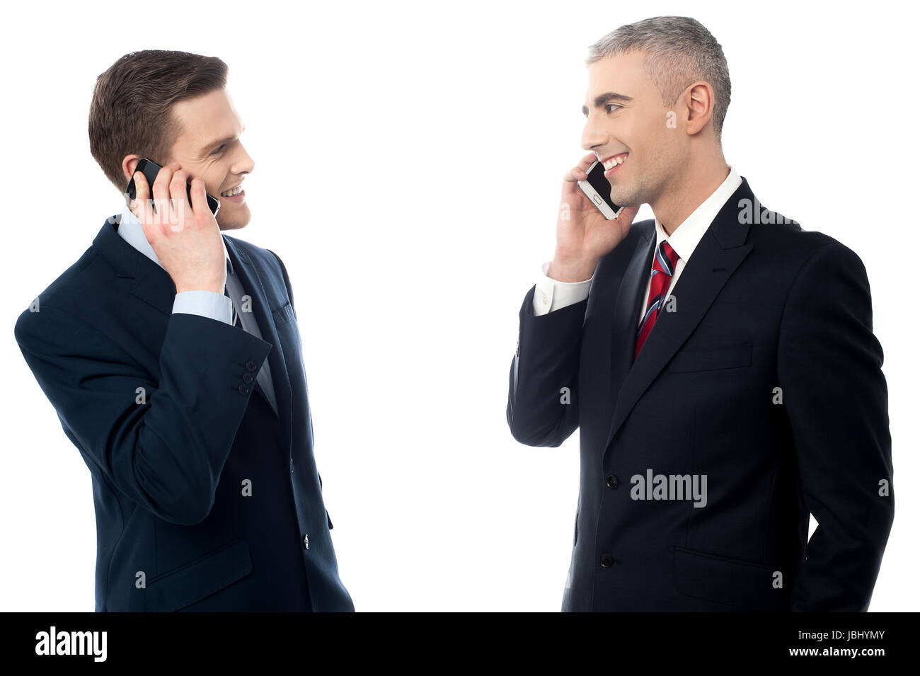 Handsome businessmen communicating through cellphone Stock Photo - Alamy