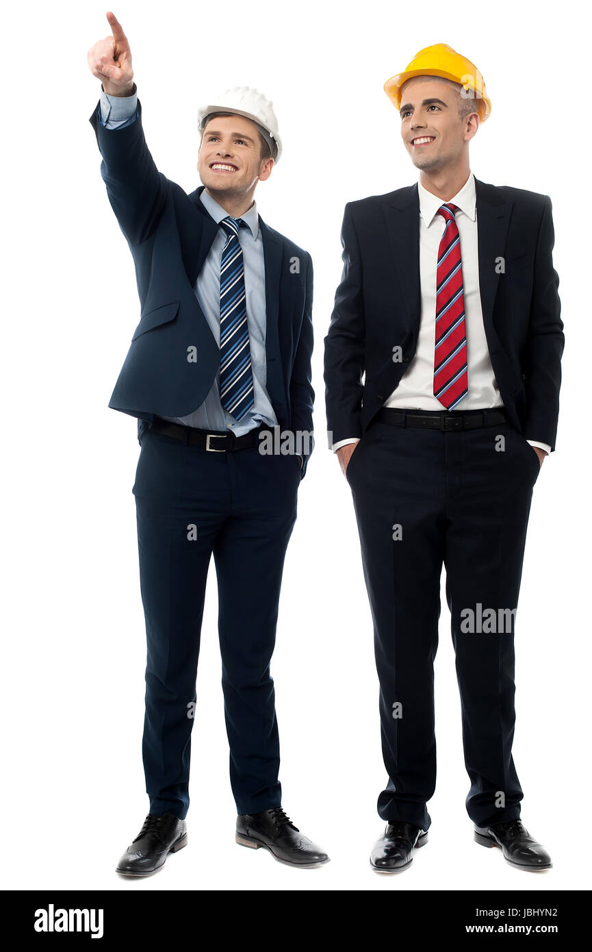 Civil engineer showing their construction area to his friend Stock ...