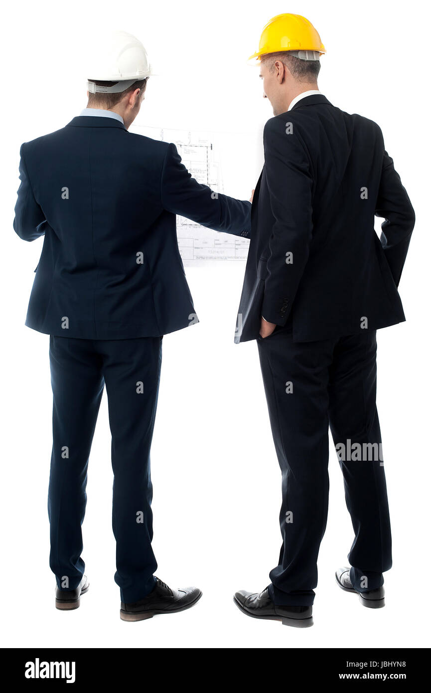 Engineers discuss about project with blueprints Stock Photo - Alamy