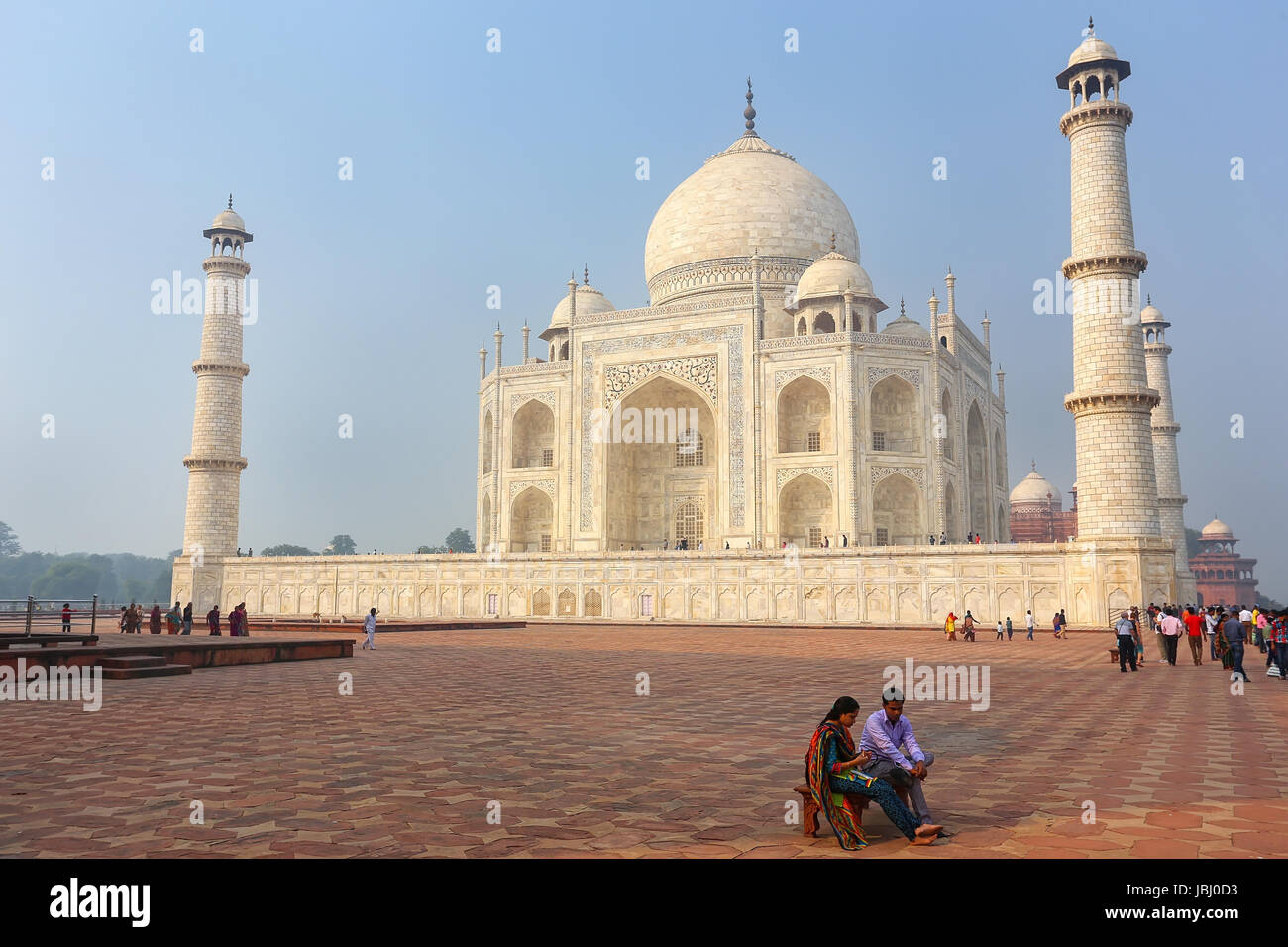 Tourists sitting on a bench at Taj Mahal complex, Agra, Uttar Pradesh ...