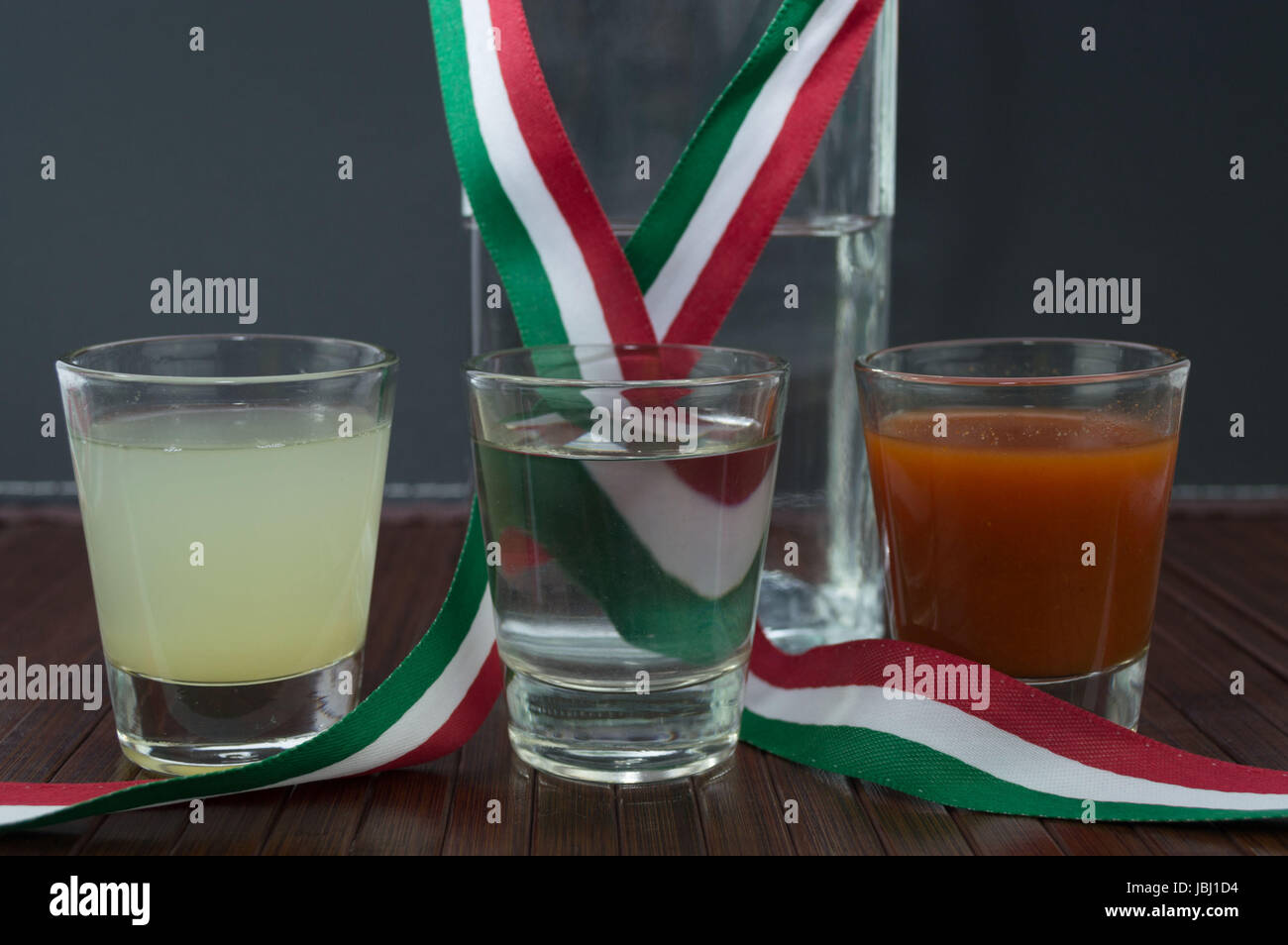 Mexican Tequila Flag made with Lime, Tequila and salsa, over a wooden ...