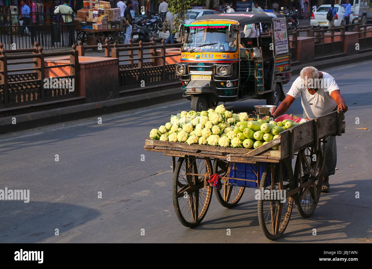 Local man pushing cart with vegetables at Johari Bazaar street in ...