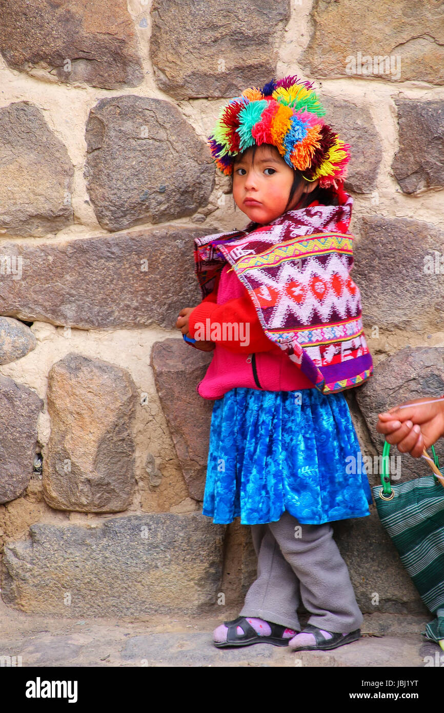 Local girl standing near Inca Fortress in Ollantaytambo, Peru ...