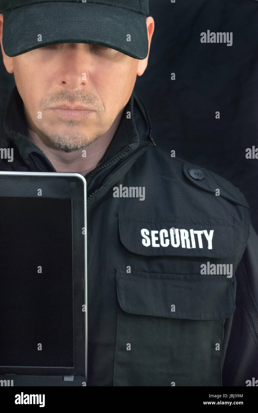 Close-up of security holding a laptop display to camera Stock Photo - Alamy