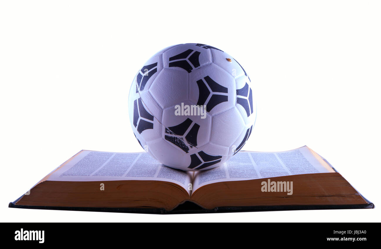 Soccer ball over book, isolated over white Stock Photo - Alamy