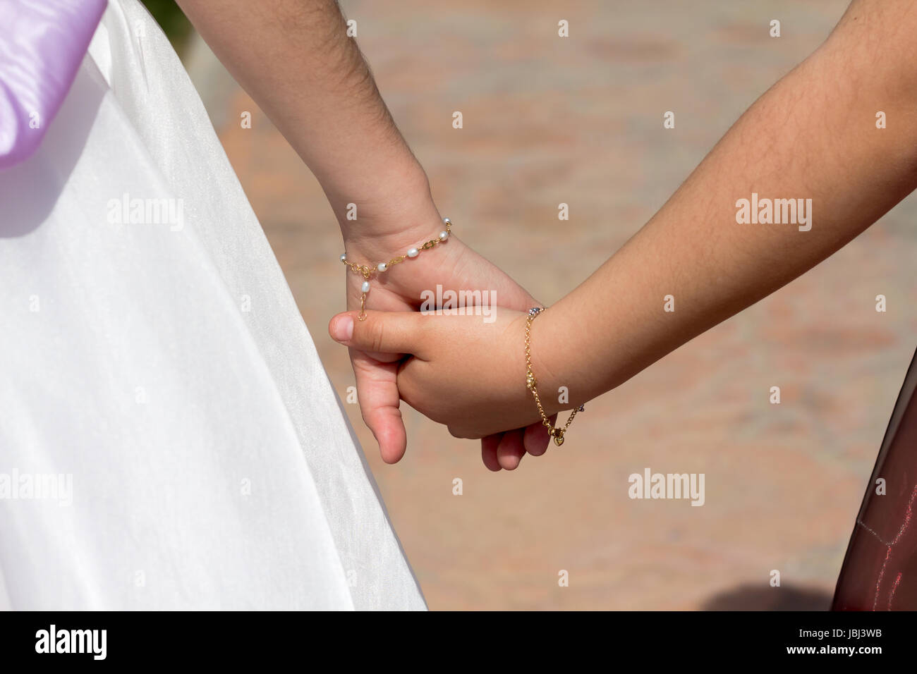 Two young girls holding their hands Stock Photo - Alamy