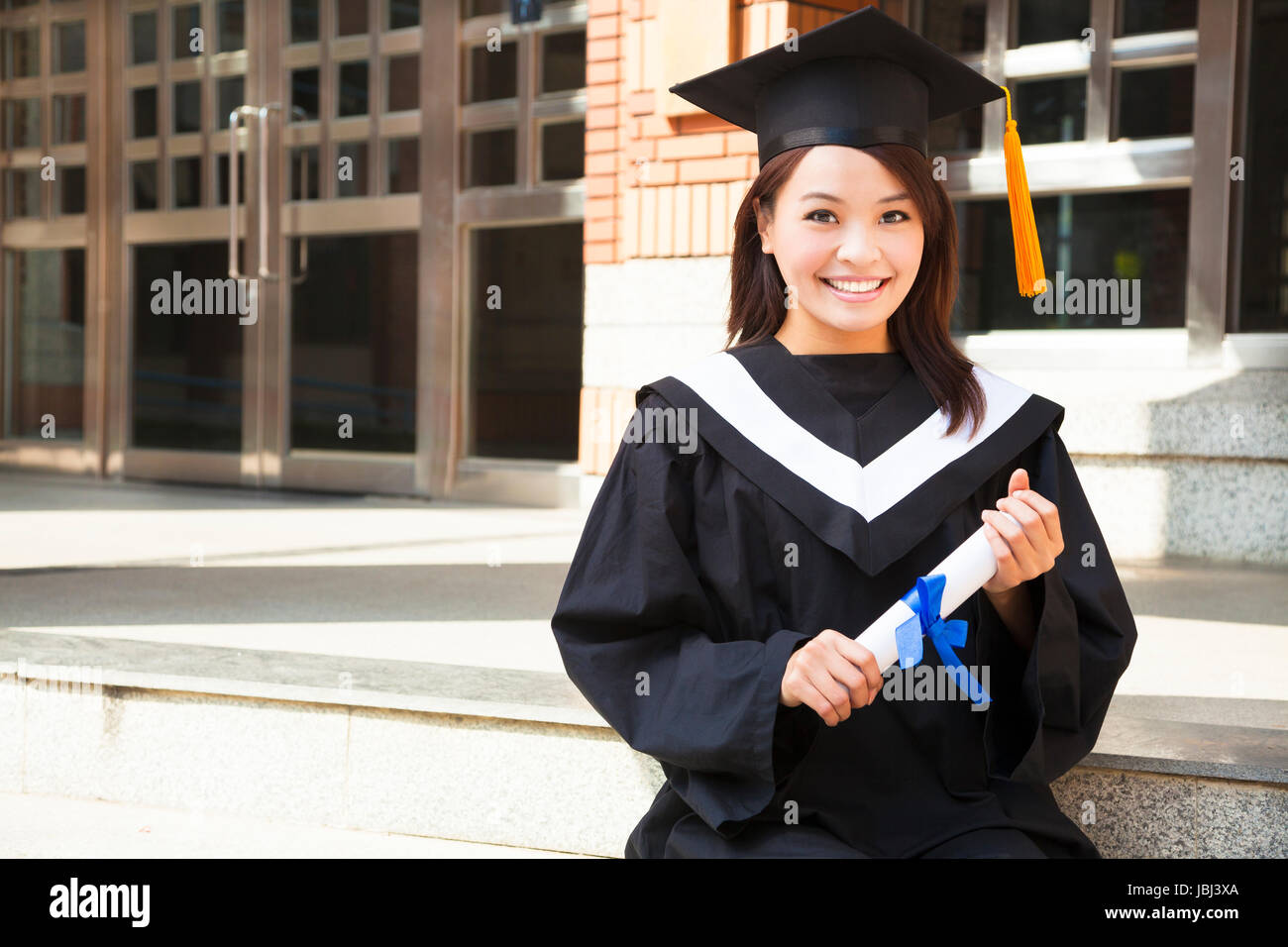 pretty college student holding a diploma at campus Stock Photo - Alamy
