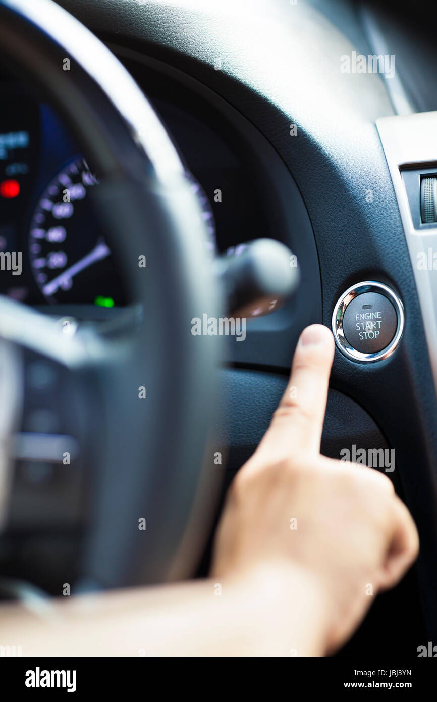 finger pressing the Engine start stop button Stock Photo - Alamy