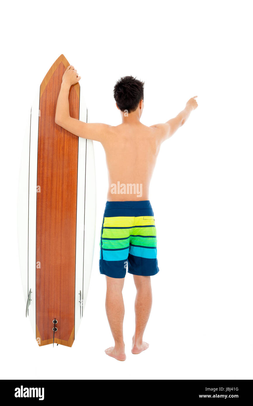 young guy standing and point forward with surfboard Stock Photo - Alamy