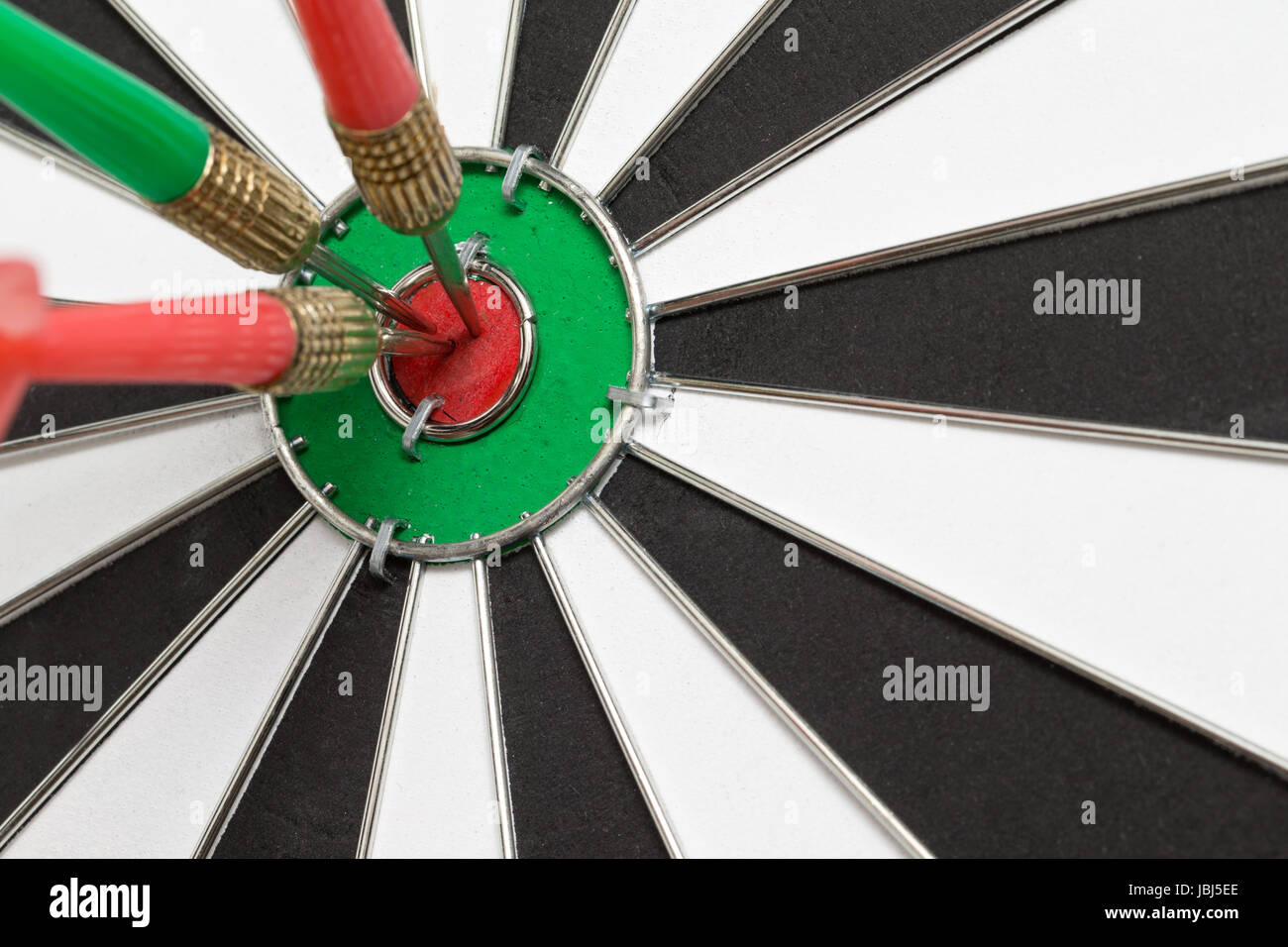 darts arrows in the target center Stock Photo - Alamy
