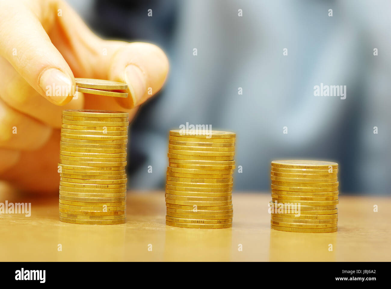 Hand put coin to money staircase isolated on white background Stock ...