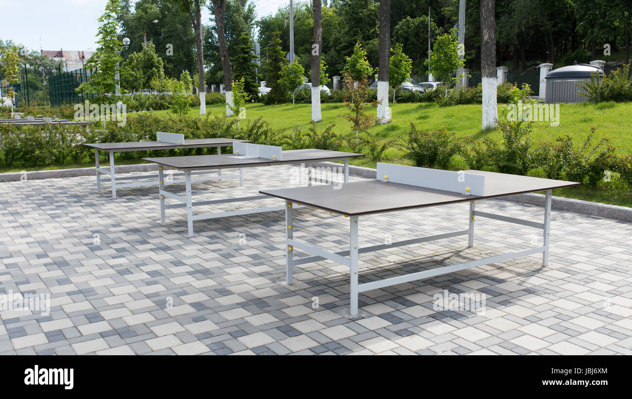 Some ping pong tables in a public park. Outdoor playground with many ...