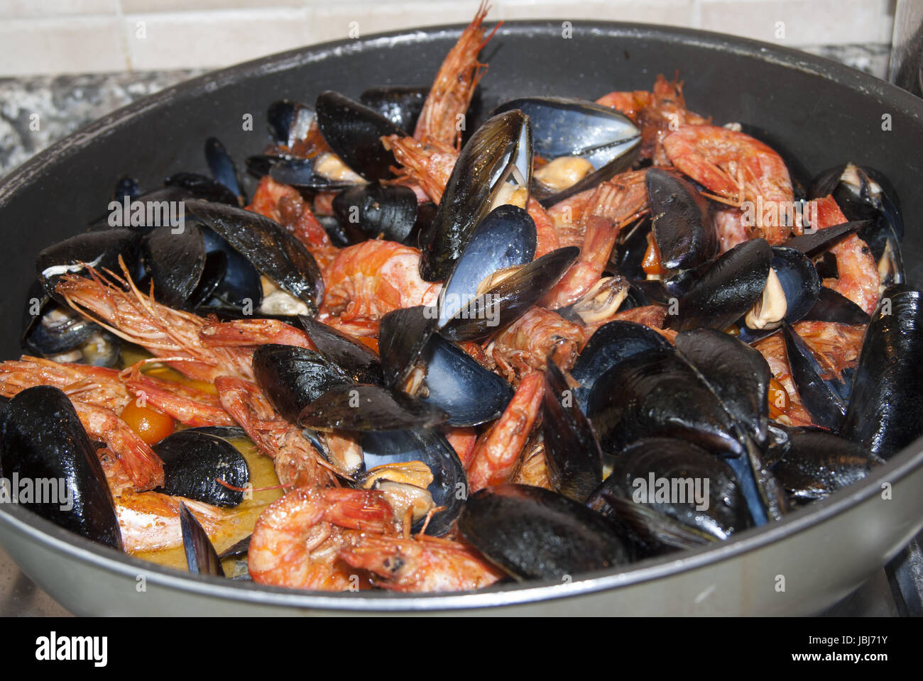 Traditional Italian sea dish:sautè of fresh fish Stock Photo - Alamy