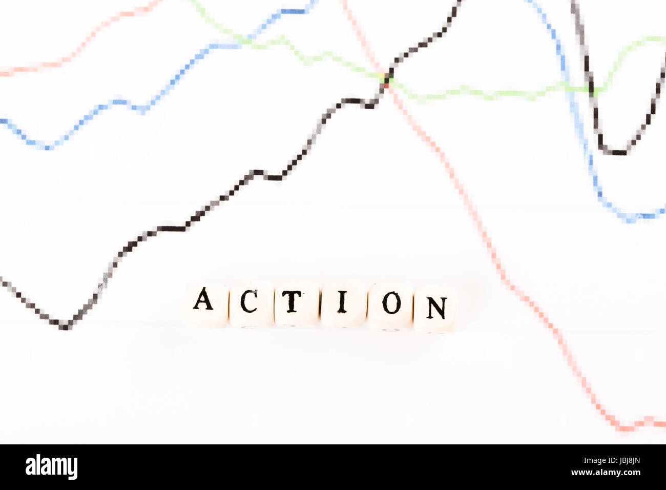 ACTION written with wood cubes letters on financial business graph ...