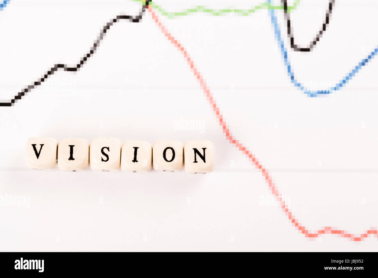 VISION written with wood cubes letters on financial business graph ...