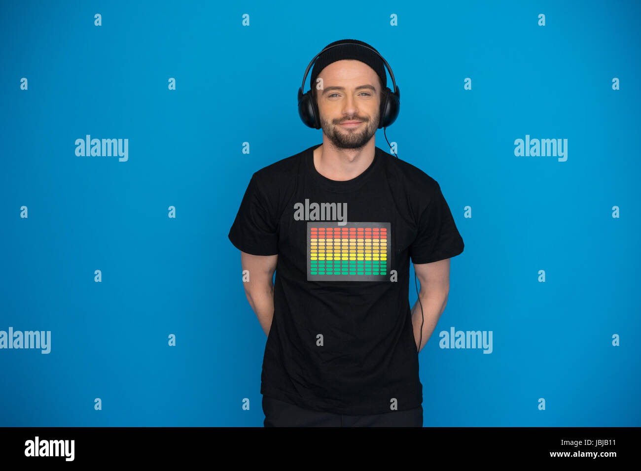 man dj wearing headphones on blue enjoying the music Stock Photo - Alamy