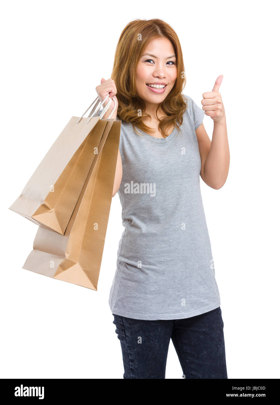 Shopping woman showing thumb up Stock Photo - Alamy