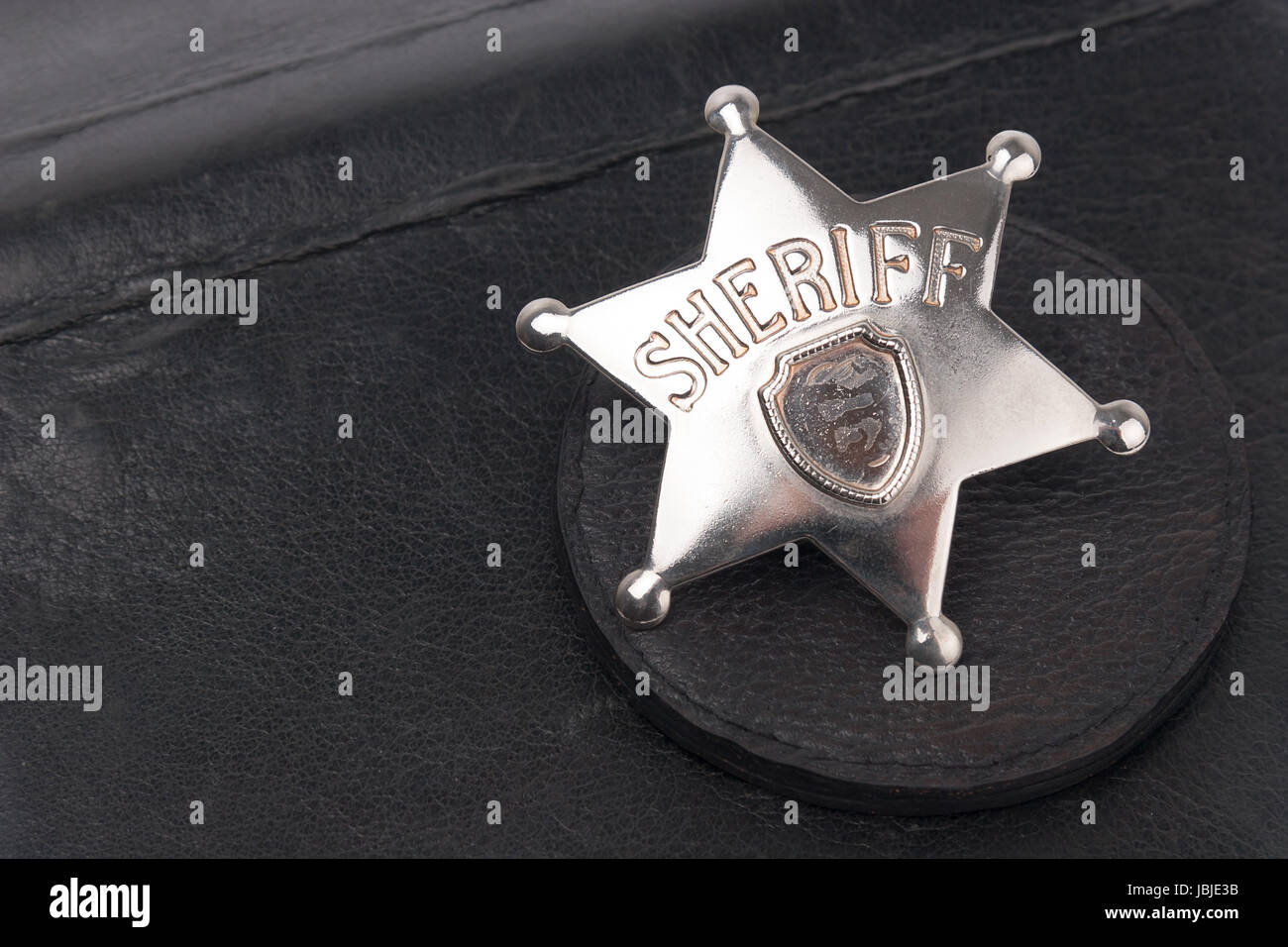 Sheriff's badge on dark background Stock Photo - Alamy