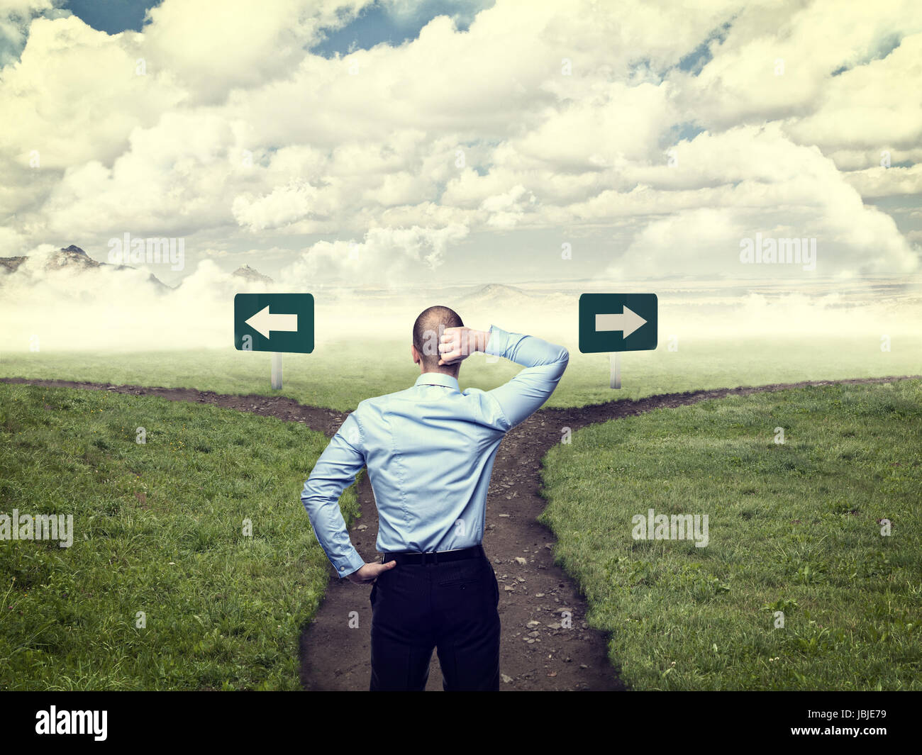 standing business man and crossroad Stock Photo - Alamy