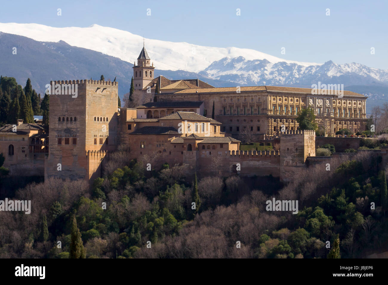 The Alhambra of Granada in Spain with Sierra Nevada snowy mountains as ...