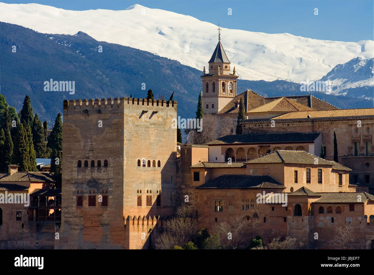 The Alhambra of Granada in Spain with Sierra Nevada snowy mountains as ...
