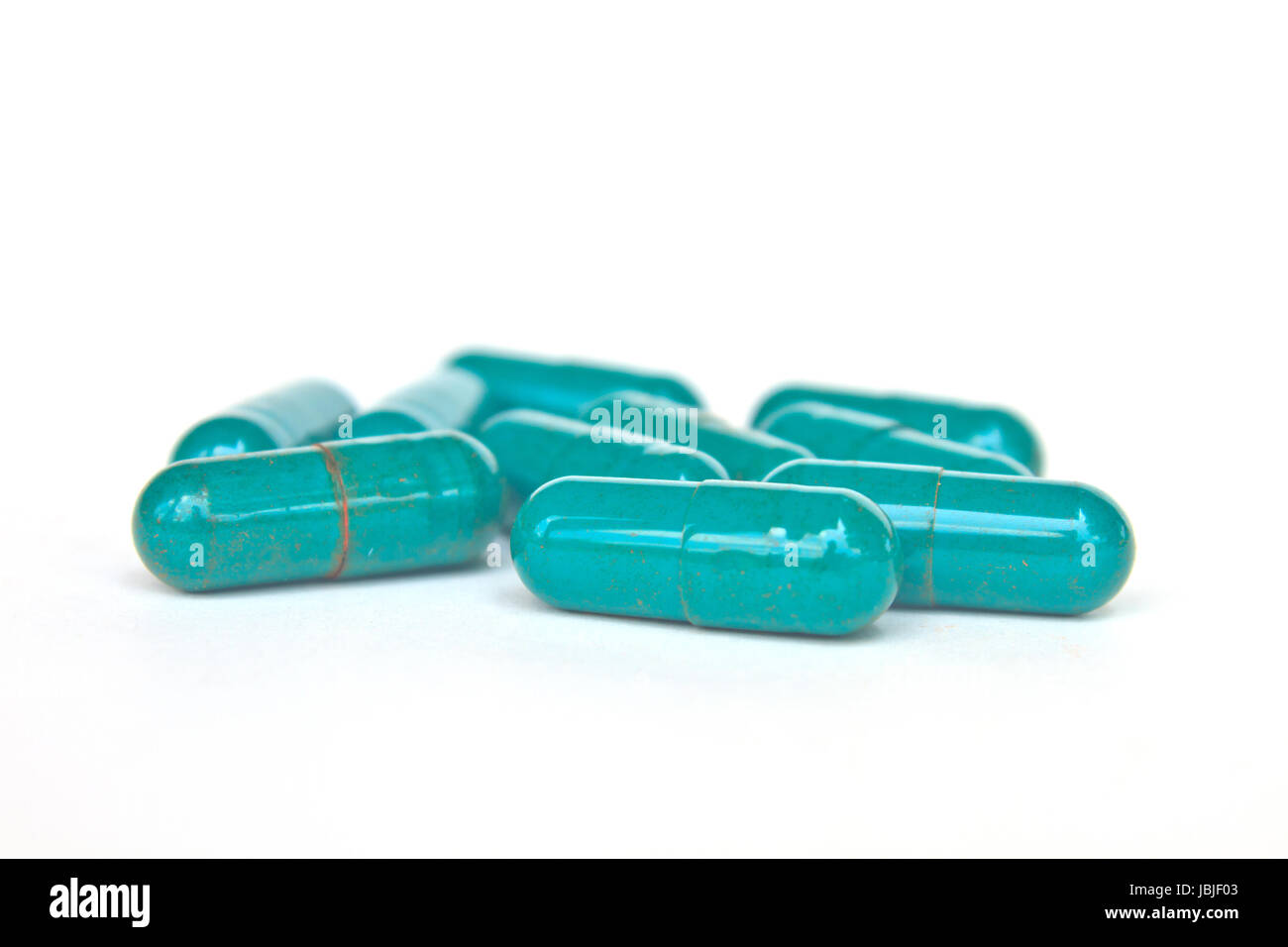 close up of green capsule isolated on white background Stock Photo - Alamy