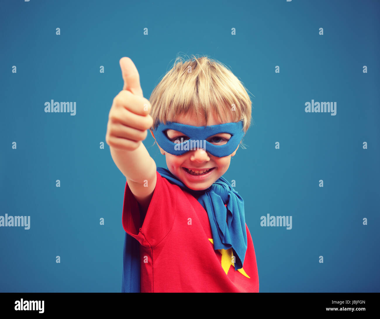 A young boy superhero giving you a thumbs up Stock Photo - Alamy