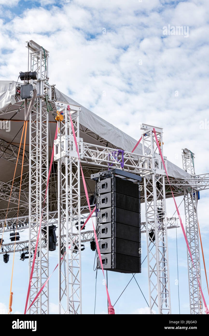 outdoor stage equipped with professional sound equipment against cloudy ...