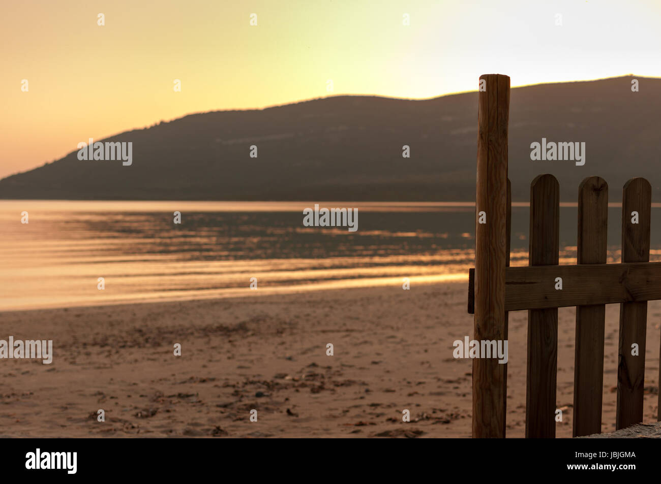 little fence on the beach in a spring sunset Stock Photo - Alamy