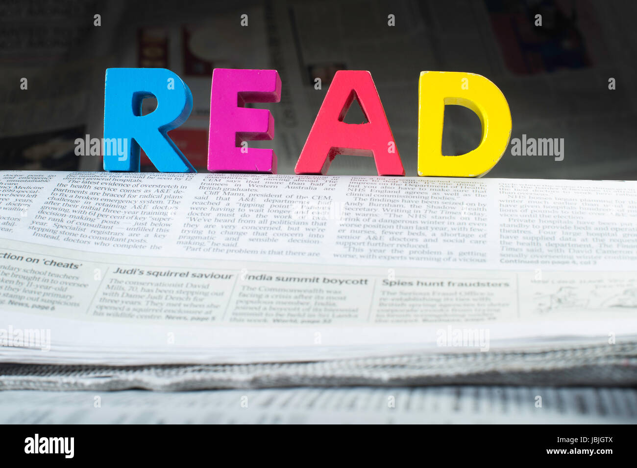 Word read on newspaper. Wooden letters Stock Photo - Alamy