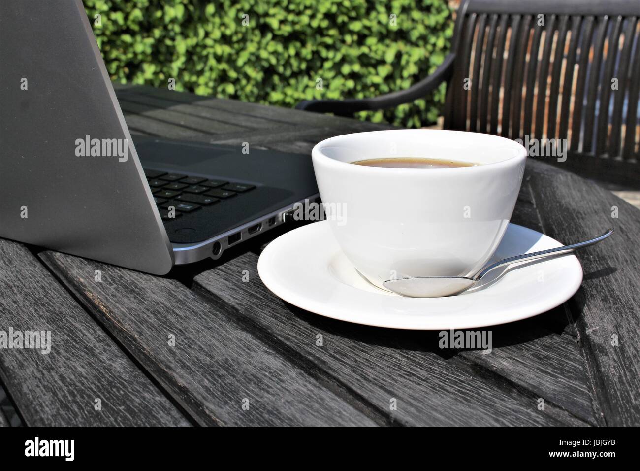 An image of a coffee with laptop in the sun Stock Photo - Alamy