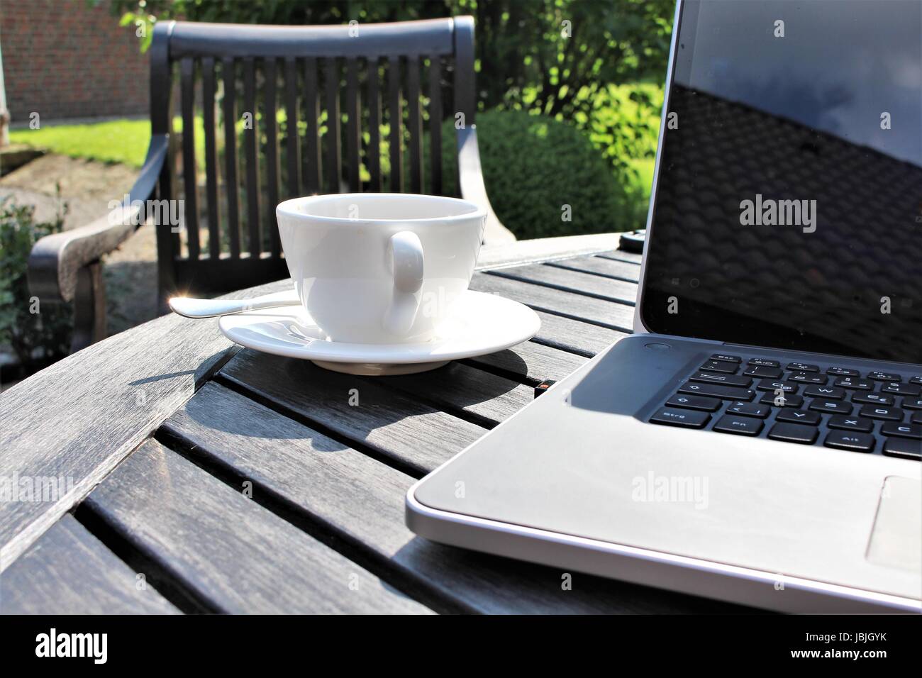 An image of a coffee with laptop in the sun Stock Photo - Alamy