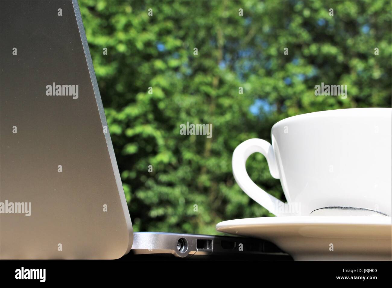 An image of a coffee with laptop in the sun Stock Photo - Alamy
