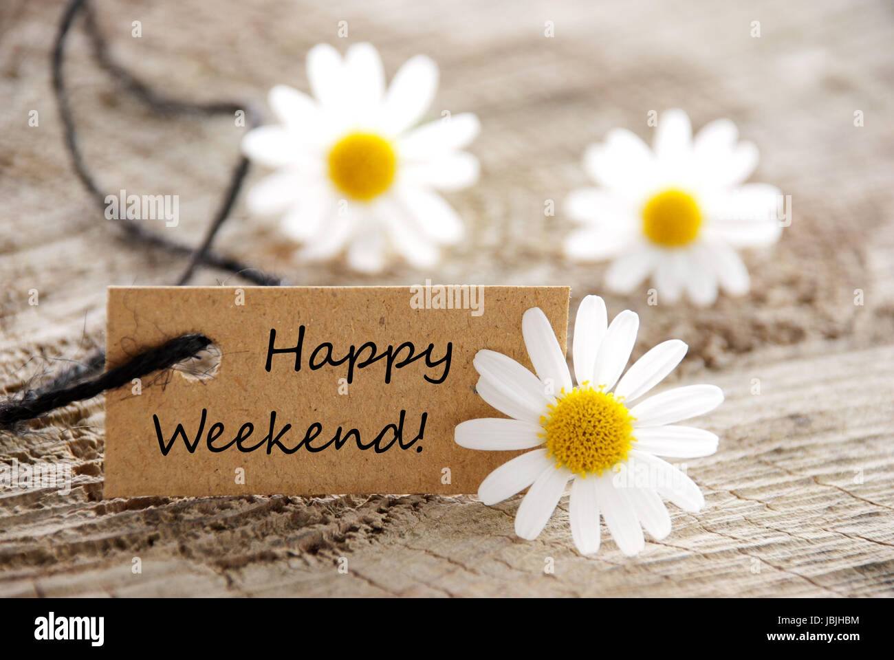 A Natural Looking Label with Happy Weekend on it and White Flowers in ...